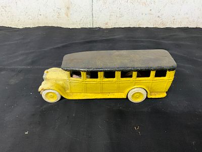 Lot 929 - Vintage Cast Iron Toy Bus with Yellow Paint | Allens Auctions
