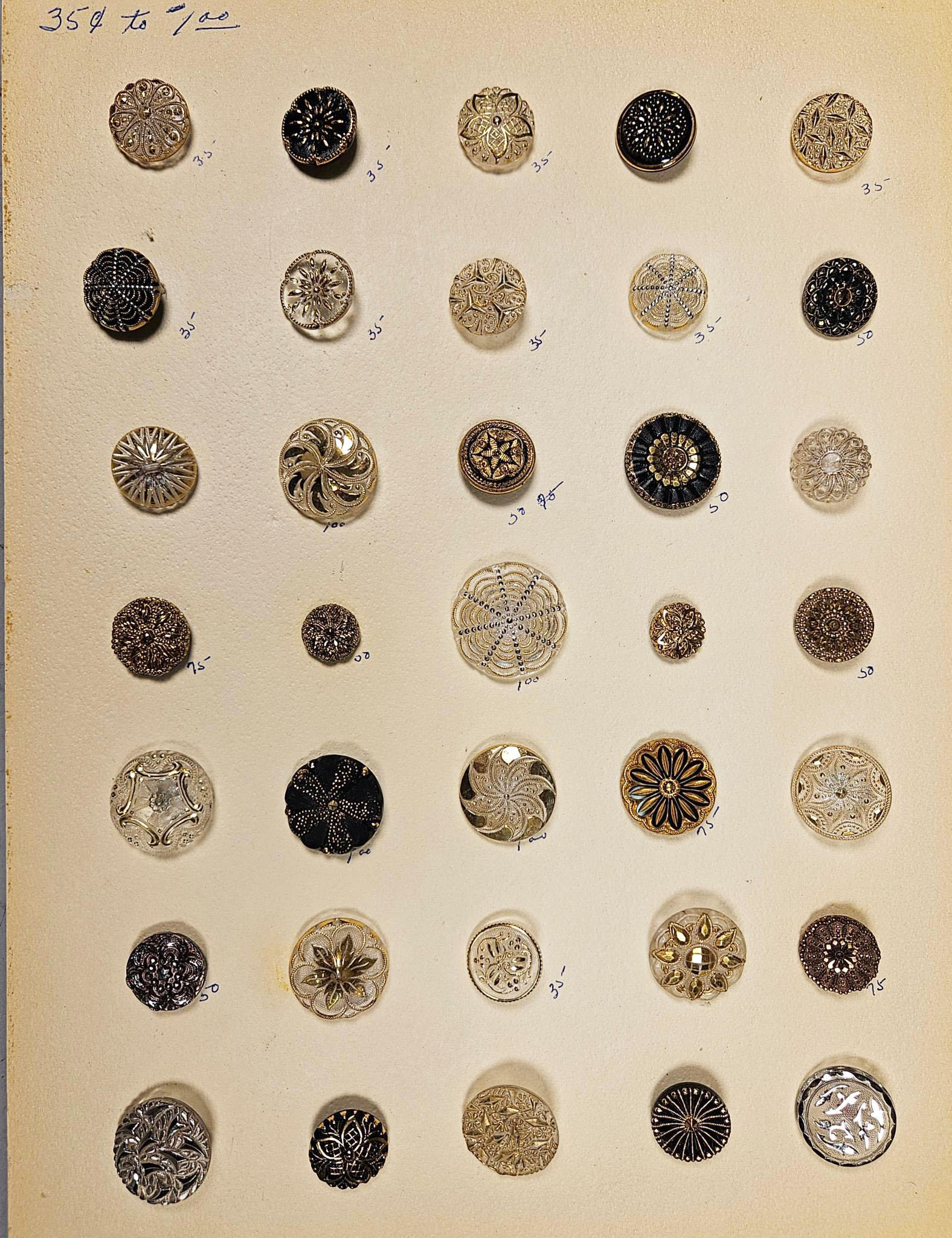 Lot 33101 - A Collection of Glass and Metallic Buttons on Display Pages | Burns Auction & Appraisal